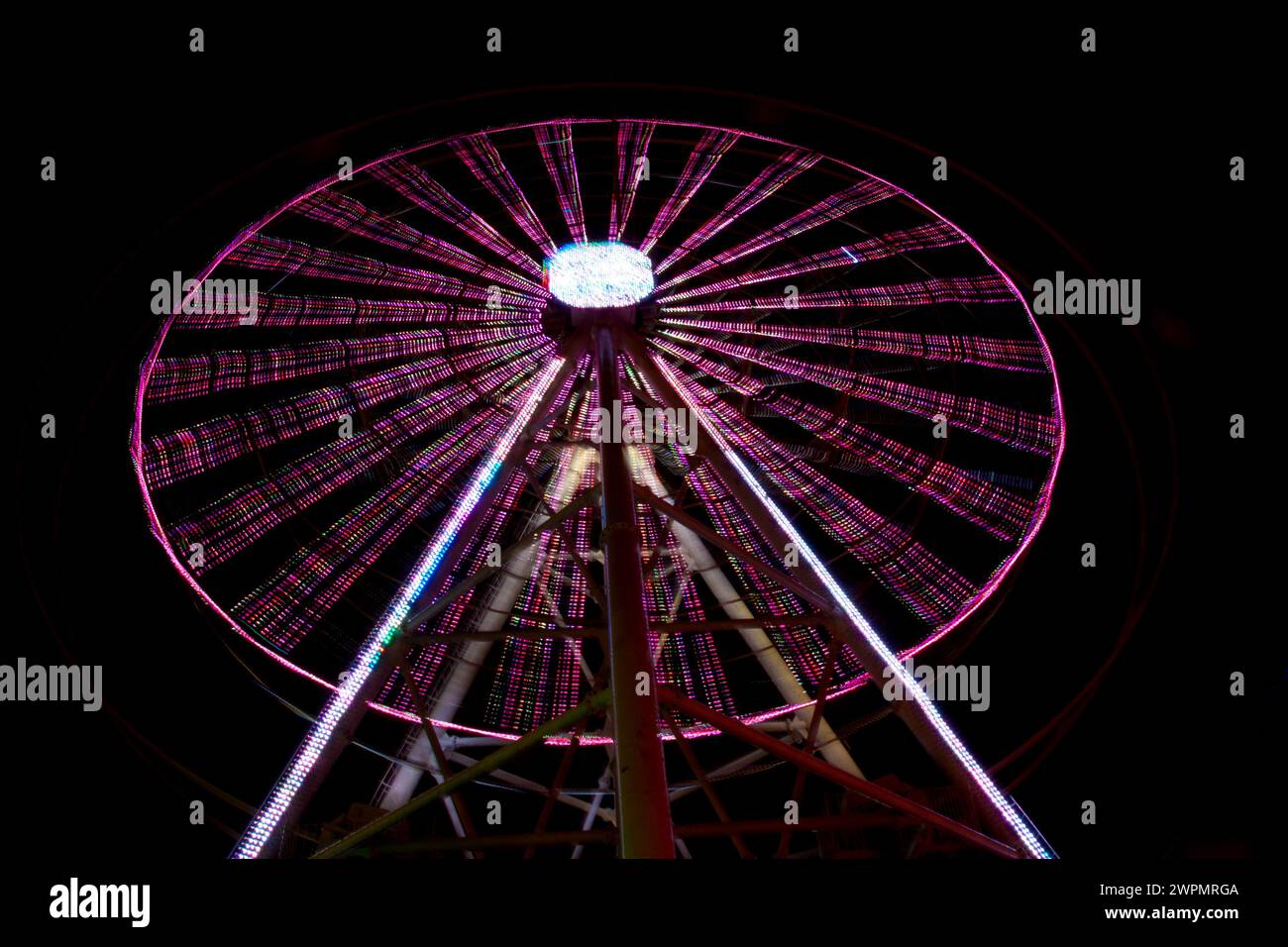 Carnival amusement park ride with swings. Spinning fair ride at night ...