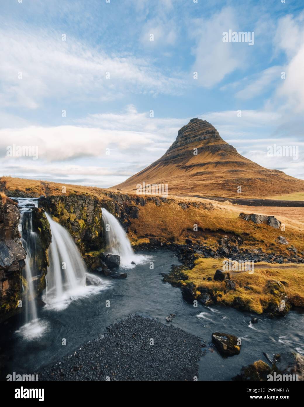 A scenic view of Kirkjufell Mountain and Kirkjufell Foss Stock Photo ...