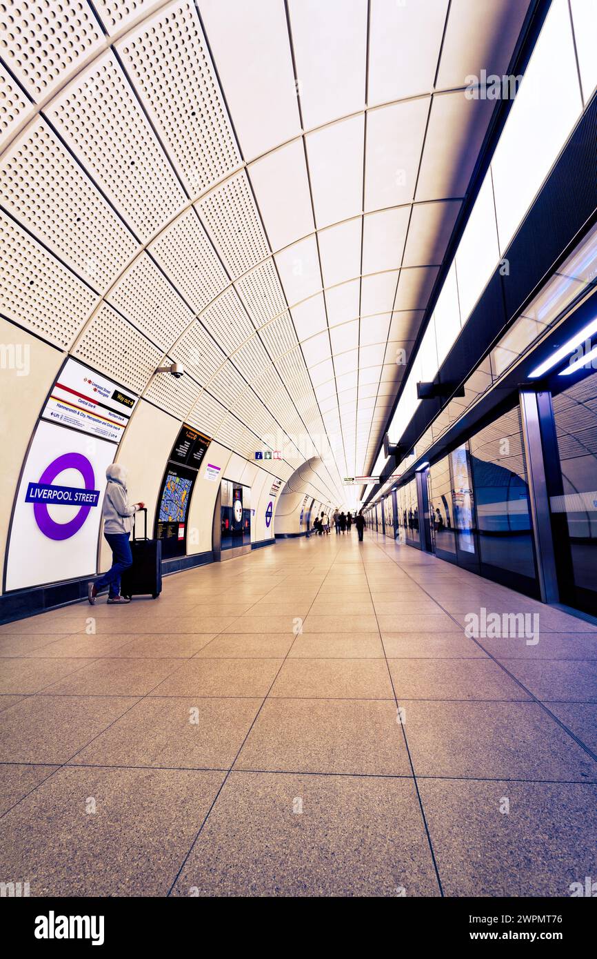 Elizabeth line platform at Liverpool Street. Person with hood up ...