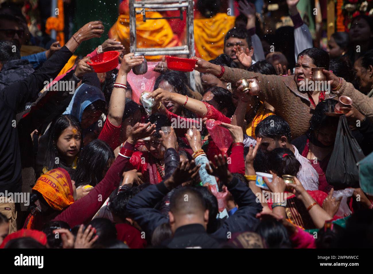 A priest adorns the idol of Lord Shiva with milk, marking the sacred ...