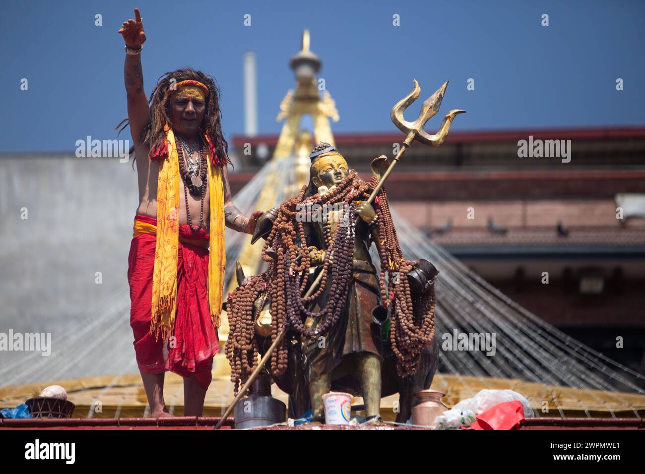 A priest adorns the idol of Lord Shiva with milk, marking the sacred ...