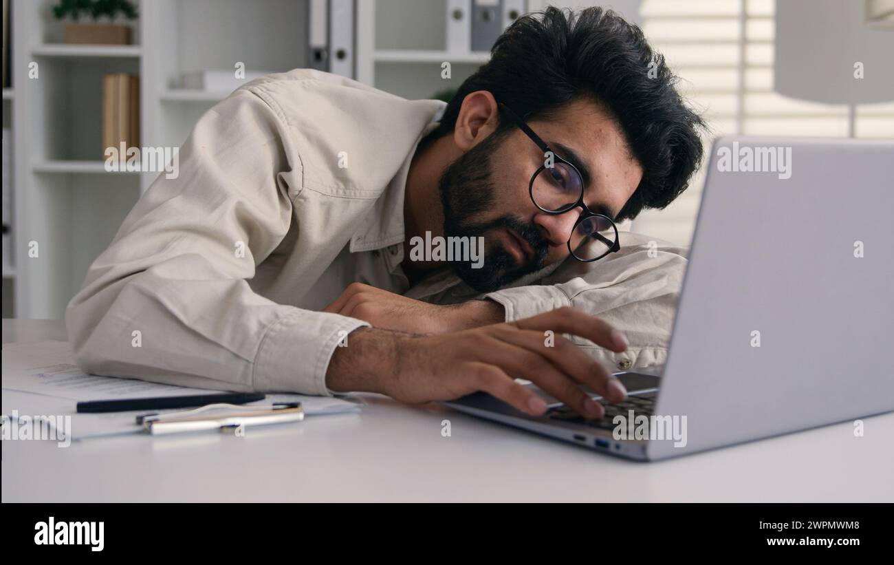 Lazy weary sleepy male manager tired exhausted Arabian Indian ...