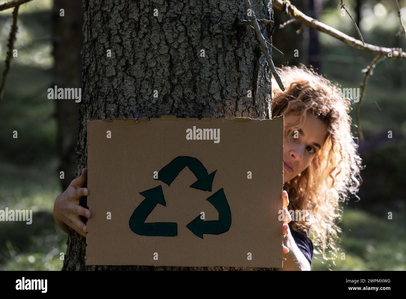 Symbol of recycling on a cardboards background.Girl holding a cardboard ...
