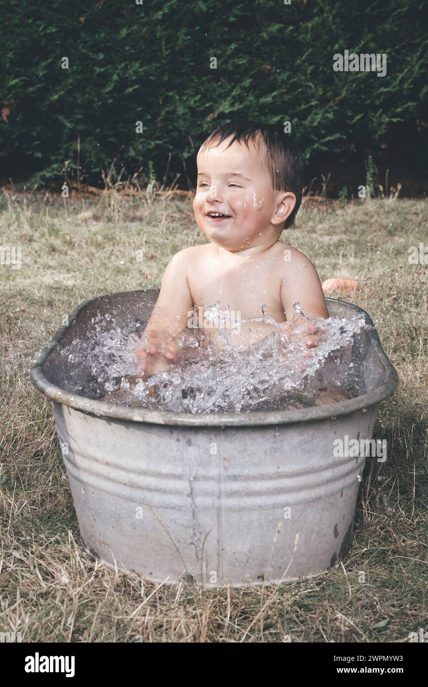 Little boy chilling in small retro sheet metal bathtub Stock Photo - Alamy