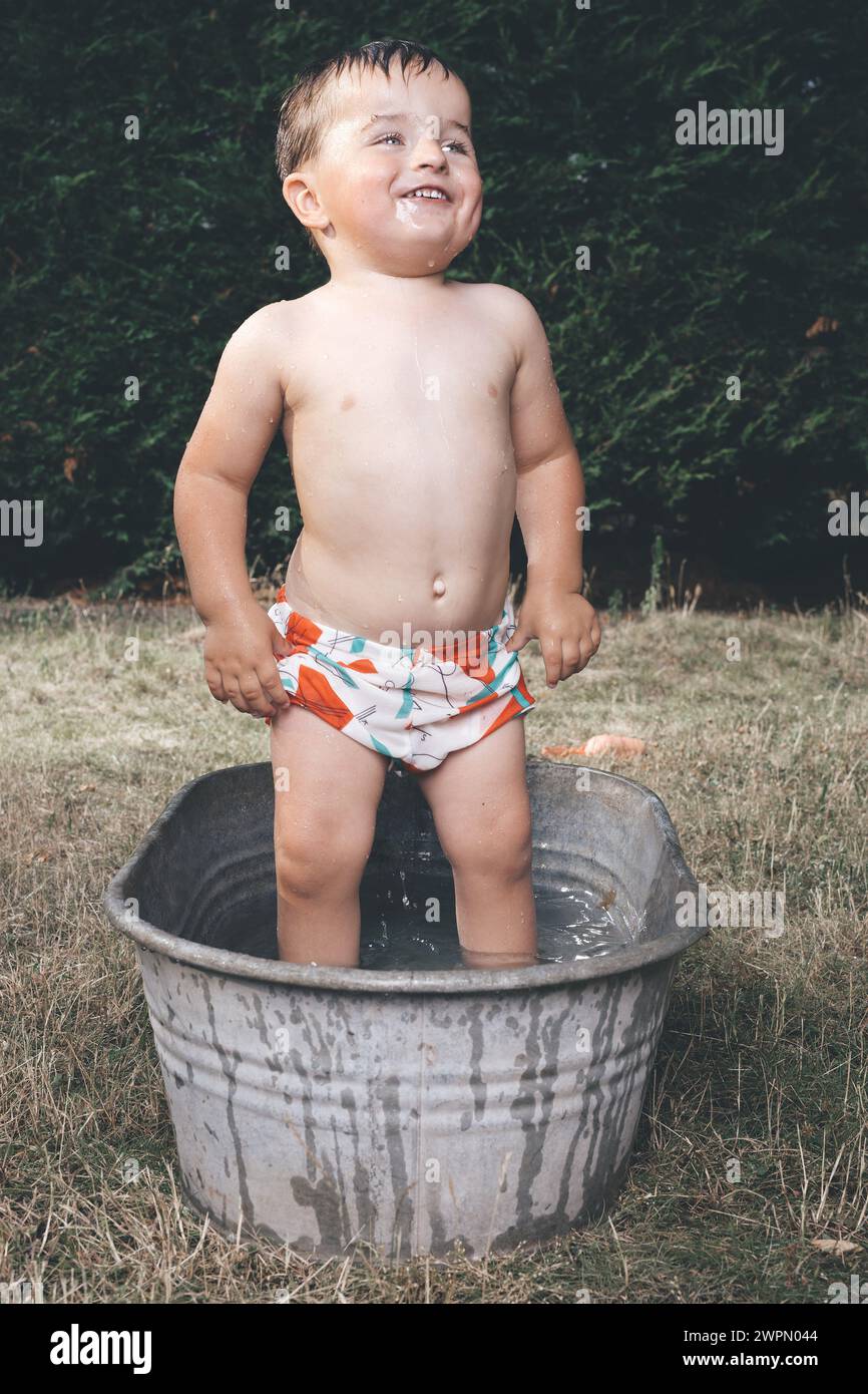 Little boy chilling in small retro sheet metal bathtub Stock Photo - Alamy