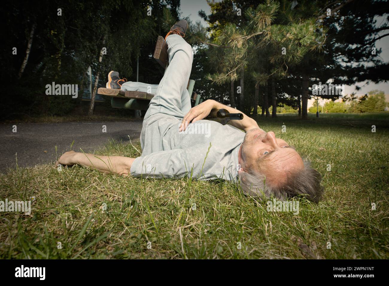Addicted old man drunked in summer city park inable to walk Stock Photo ...