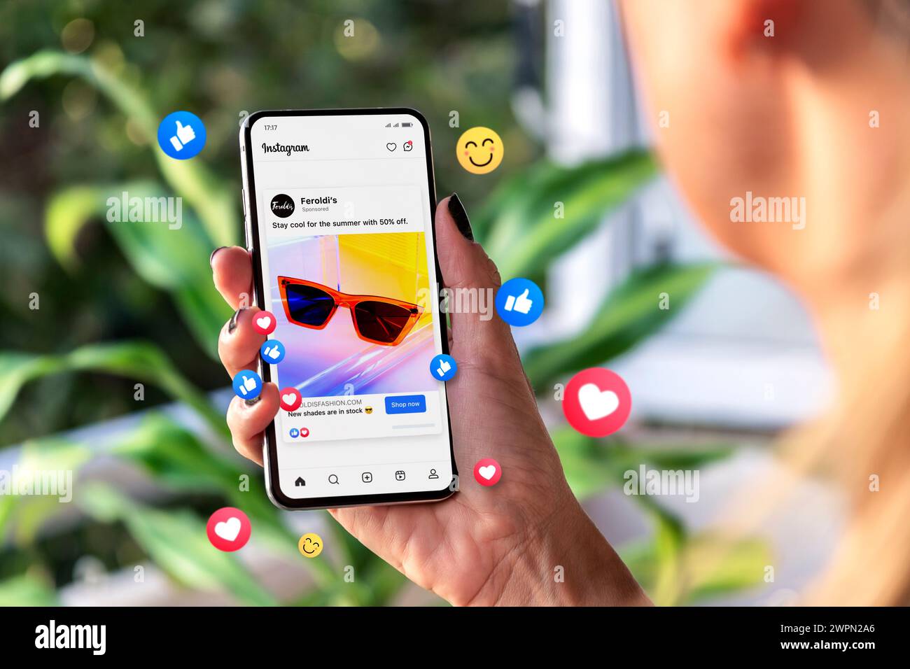 Meta ads on mobile phone screen. Woman holding smartphone showing ...