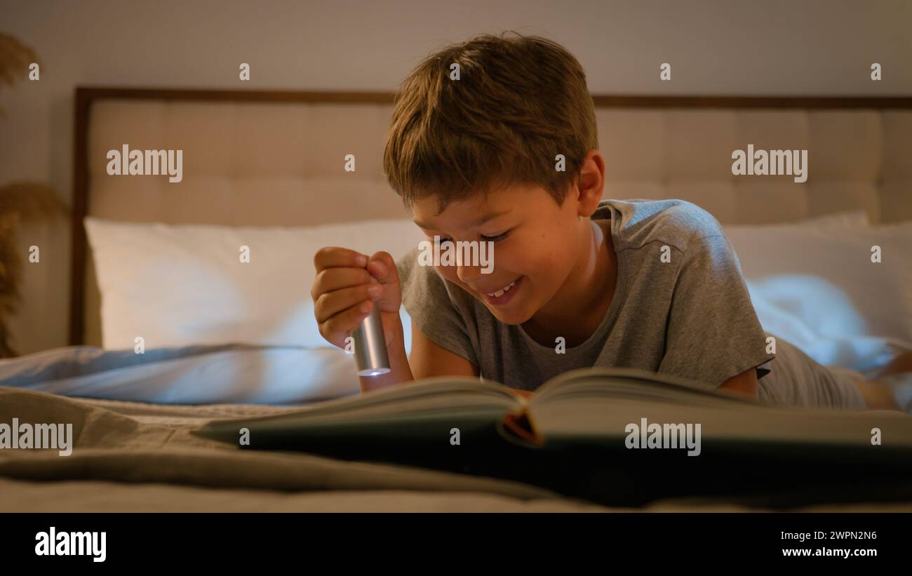 Smiling happy little cute caucasian child kid boy schoolboy reading ...