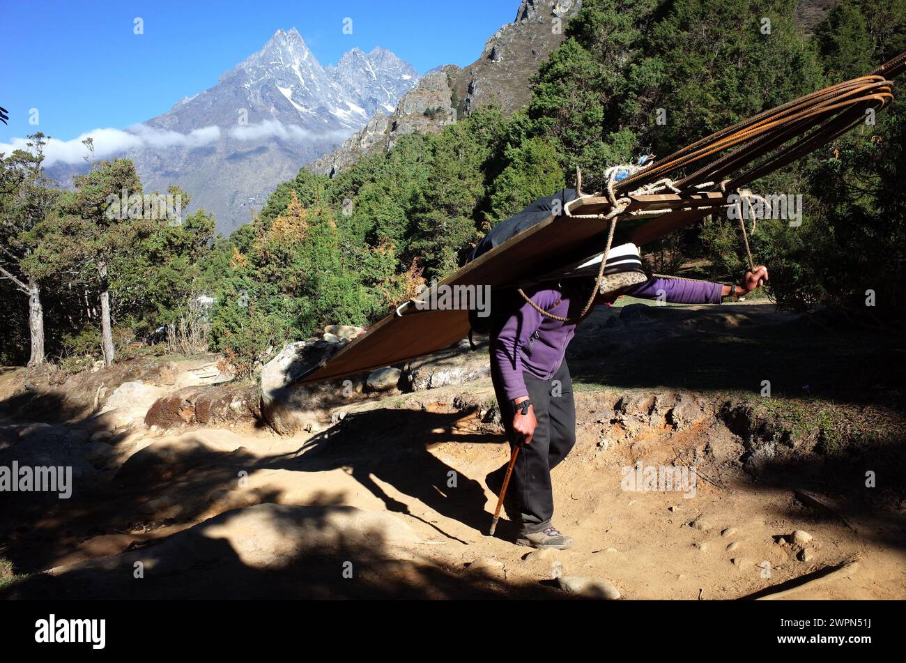 Porter carries super heavy load in Himalayas mountains. Everest trek ...