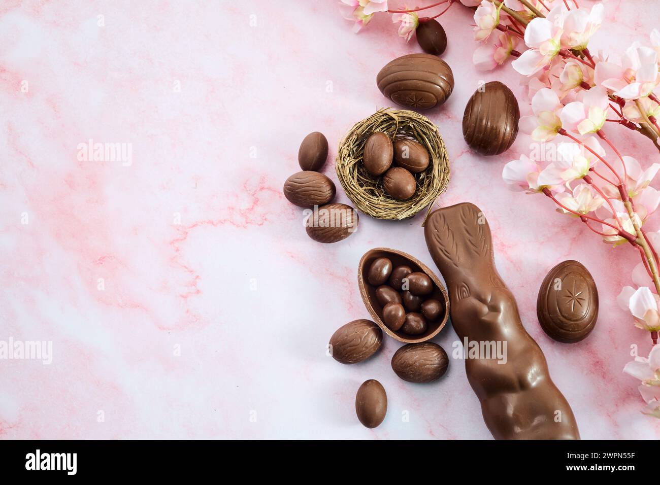 Chocolate easter eggs and bunnies on pink marble background Stock Photo ...