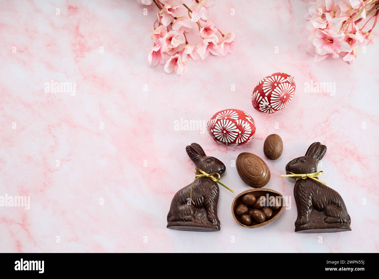 Chocolate easter eggs and bunnies on pink marble background Stock Photo ...