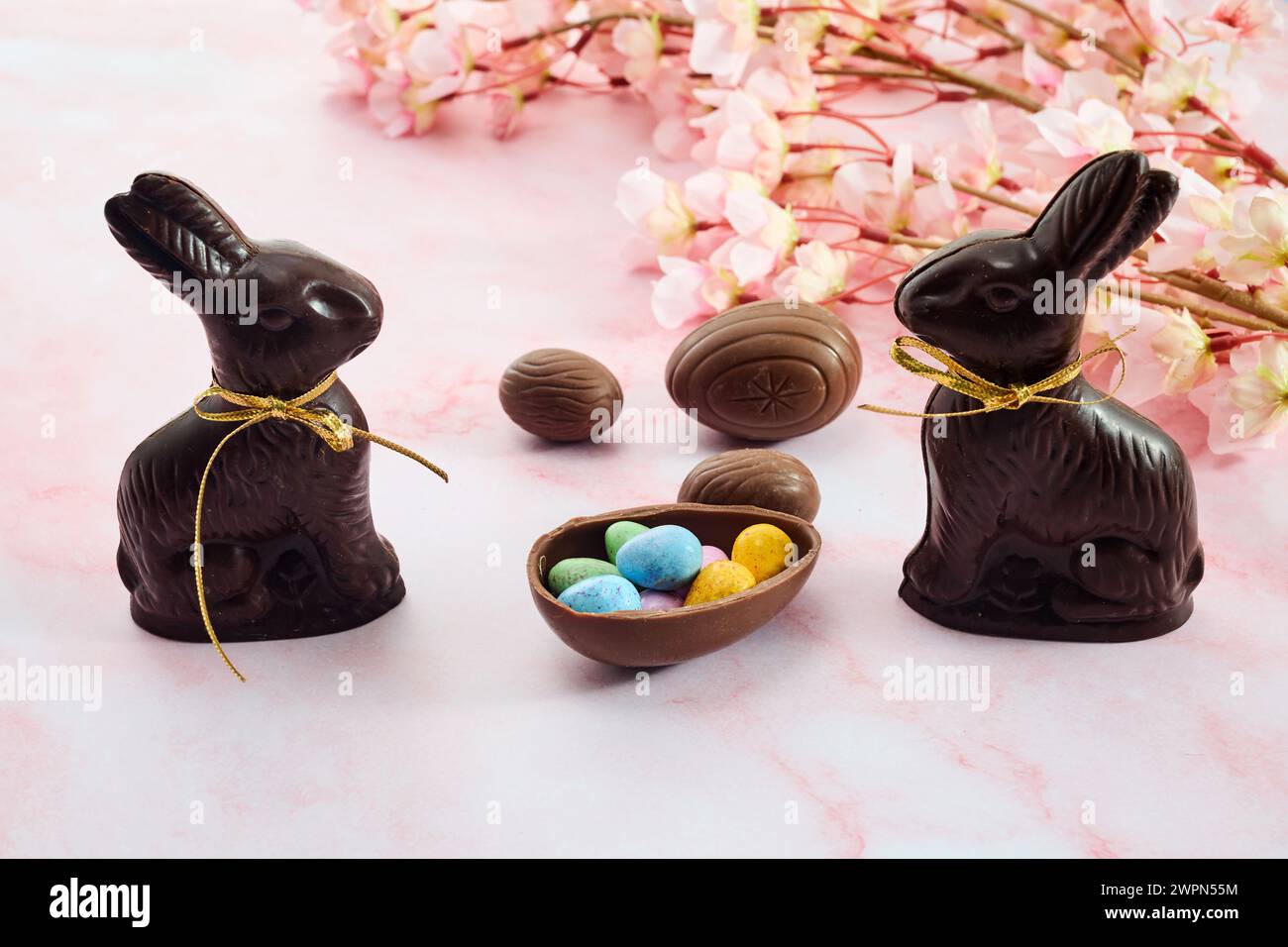 Chocolate easter eggs and bunnies on pink marble background Stock Photo ...