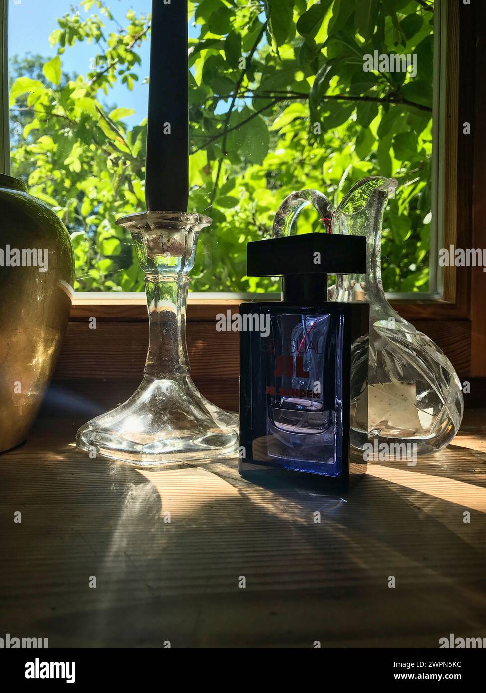 still life, perfume, candlestick, window sill Stock Photo - Alamy