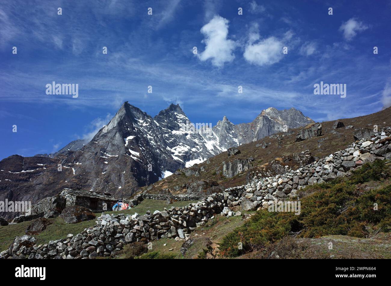 Hiking in Nepal Himalayas, Stone wall and mountain ridge of Khumuche ...