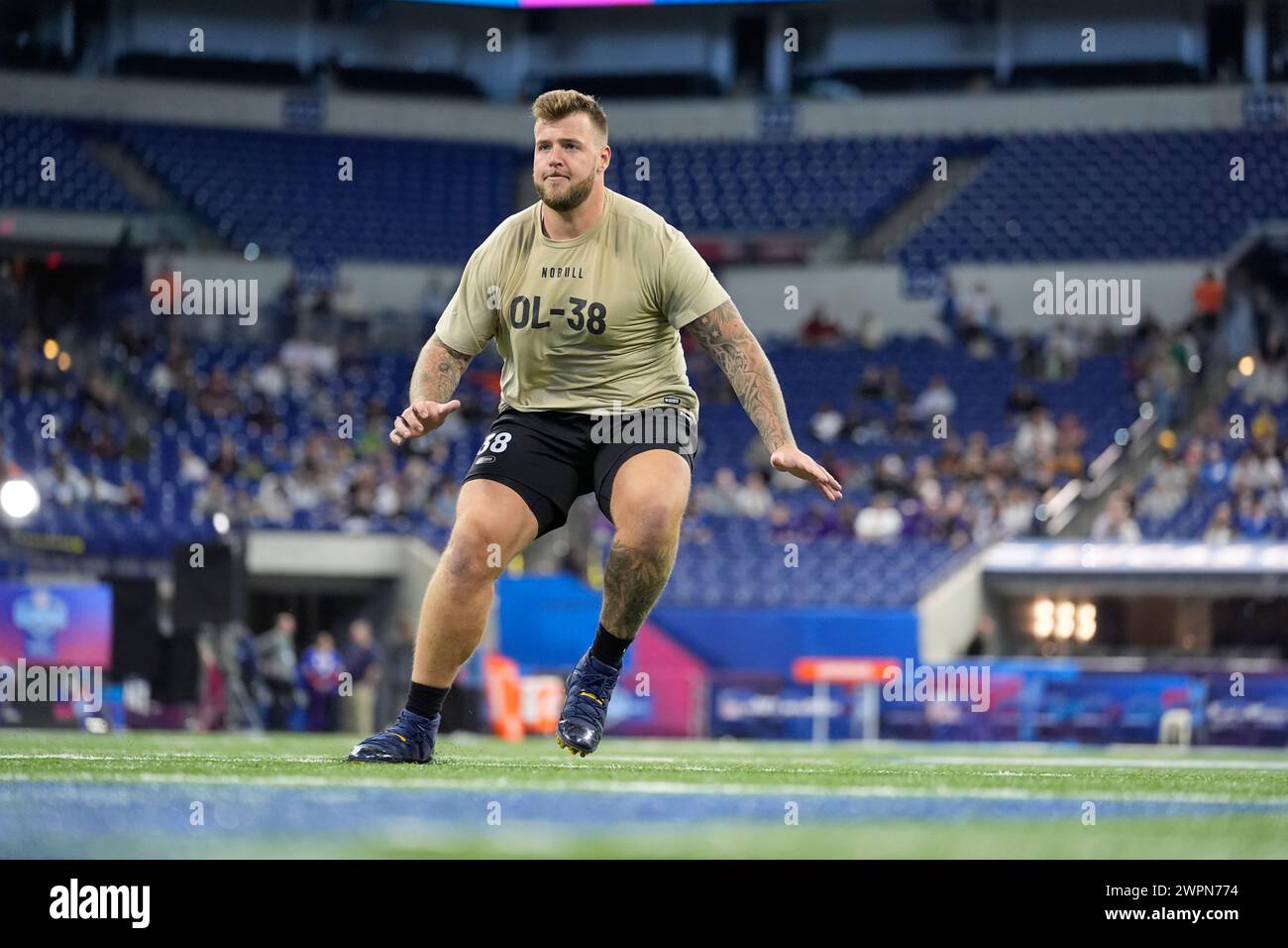 Michigan offensive lineman Trevor Keegan runs a drill at the NFL ...