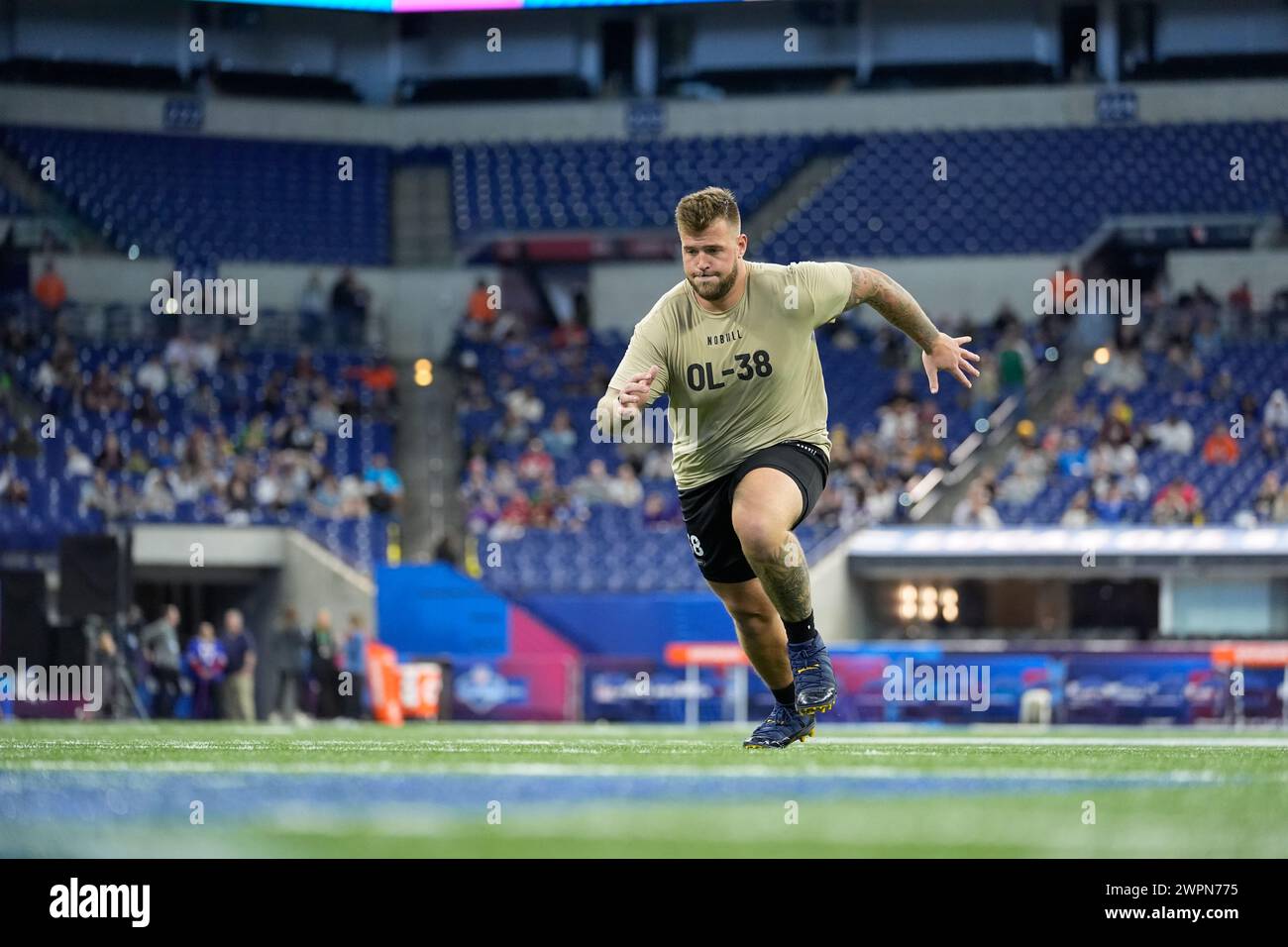 Michigan offensive lineman Trevor Keegan runs a drill at the NFL ...