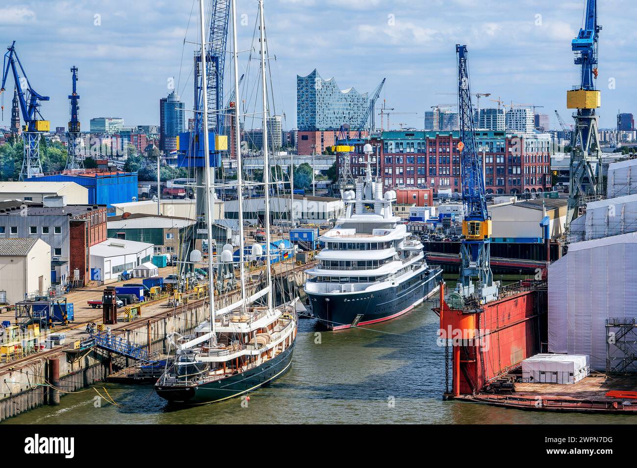 Yachts in the shipyard in hamburg harbor with the elbphilharmonie hi ...