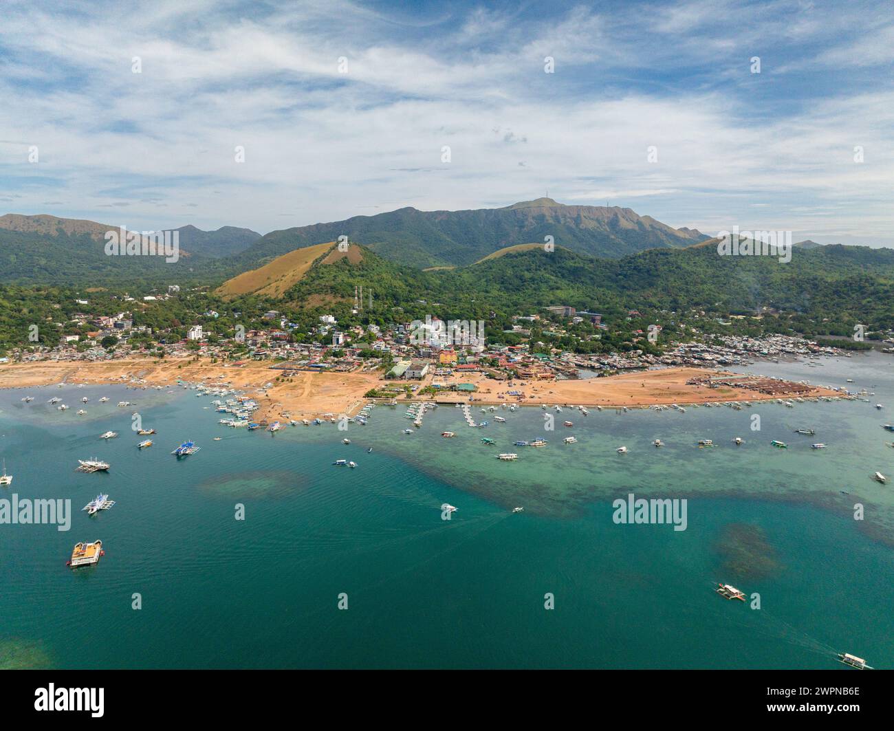 Coastal town city with boats over turquoise water and residential ...