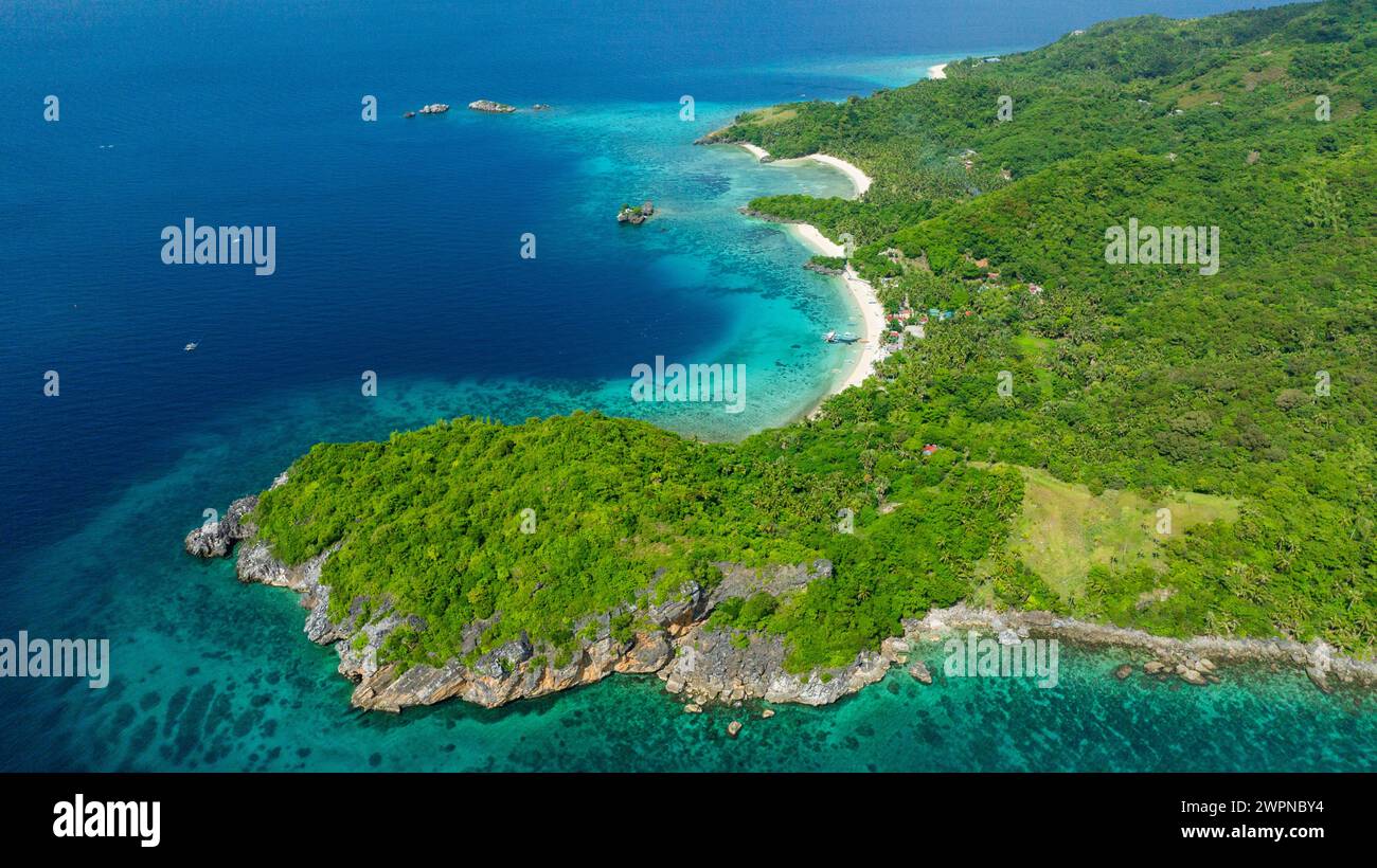 Rocky coastal with turquoise water and sandy beach in Cobrador Island ...