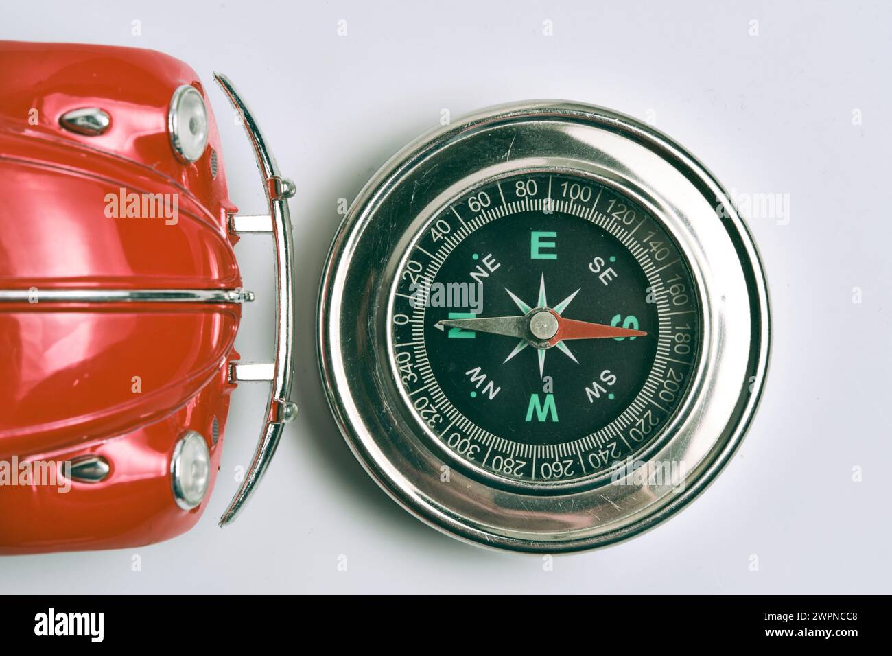 Hood red car and compass pointing south. Concept traveling by car Stock ...
