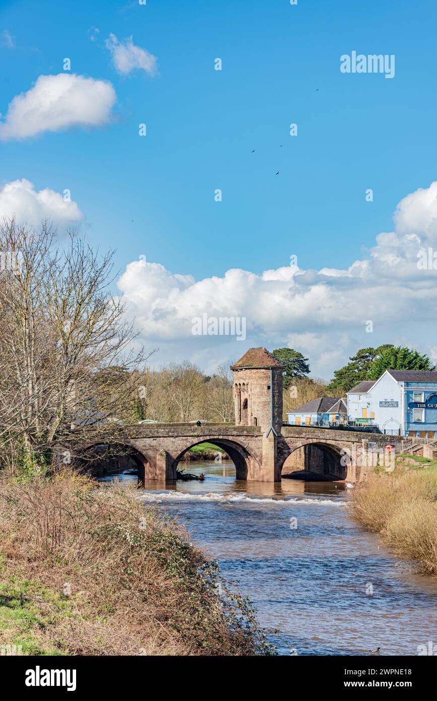 The Historic Monnow bridge over the river Monnow in the Welsh town of ...