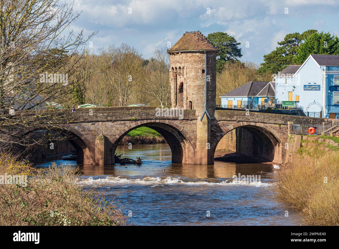 The Historic Monnow bridge over the river Monnow in the Welsh town of ...