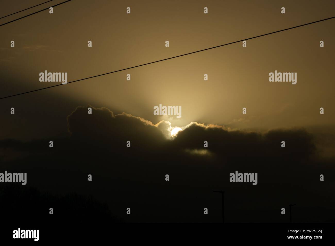 Sunrise captured on a summer morning. The clouds hug the sun with ...