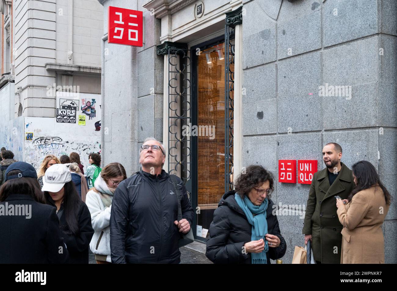 Shoppers and pedestrians walk past the Japanese clothing brand store ...