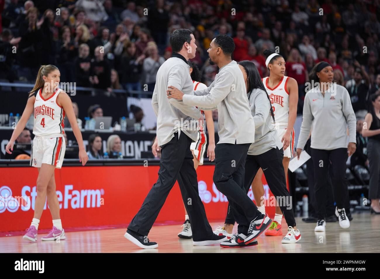 Ohio State head coach Kevin McGuff, center left, is held back by assistant coaches after ...