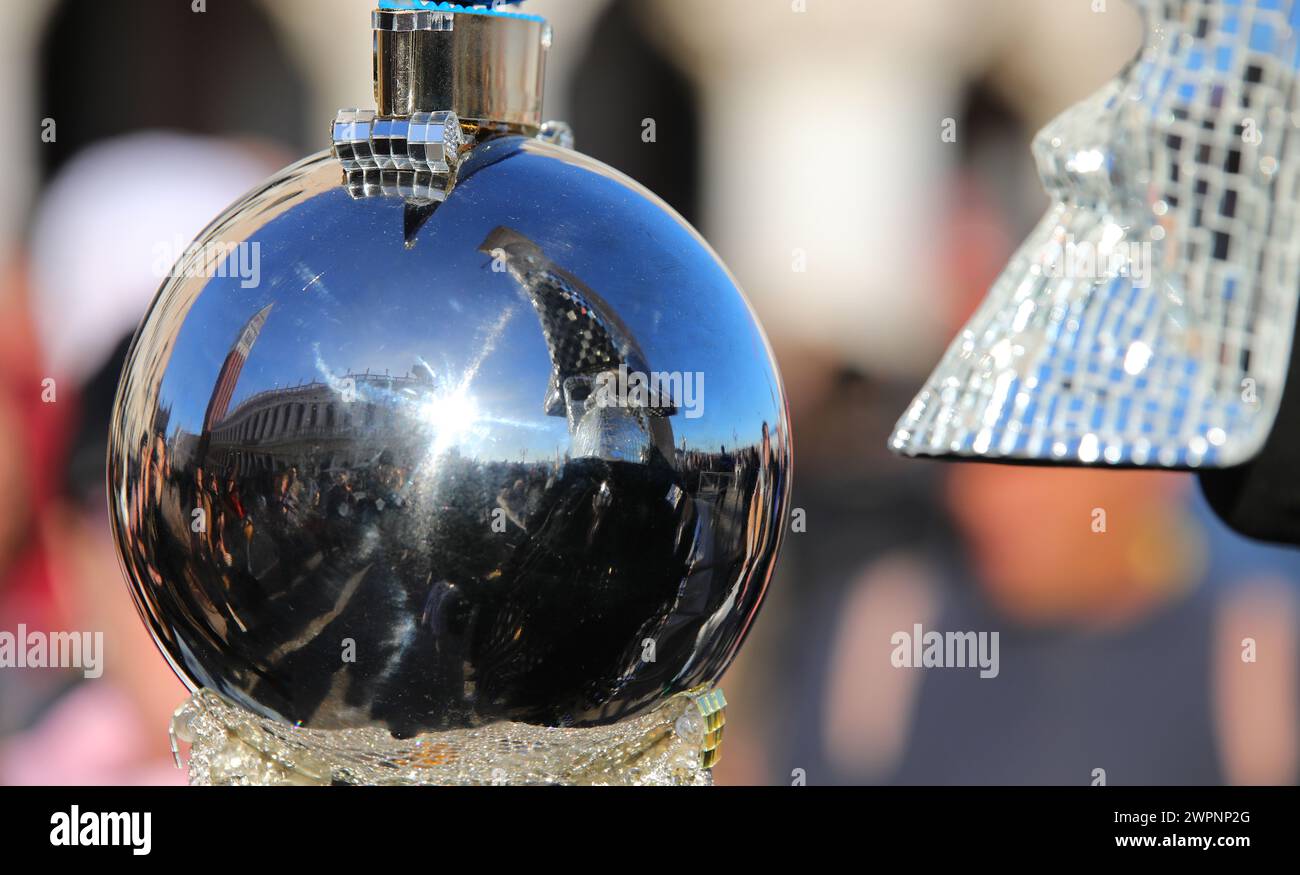 Spherical mirror reflecting Venetian landmarks and a mask with ...