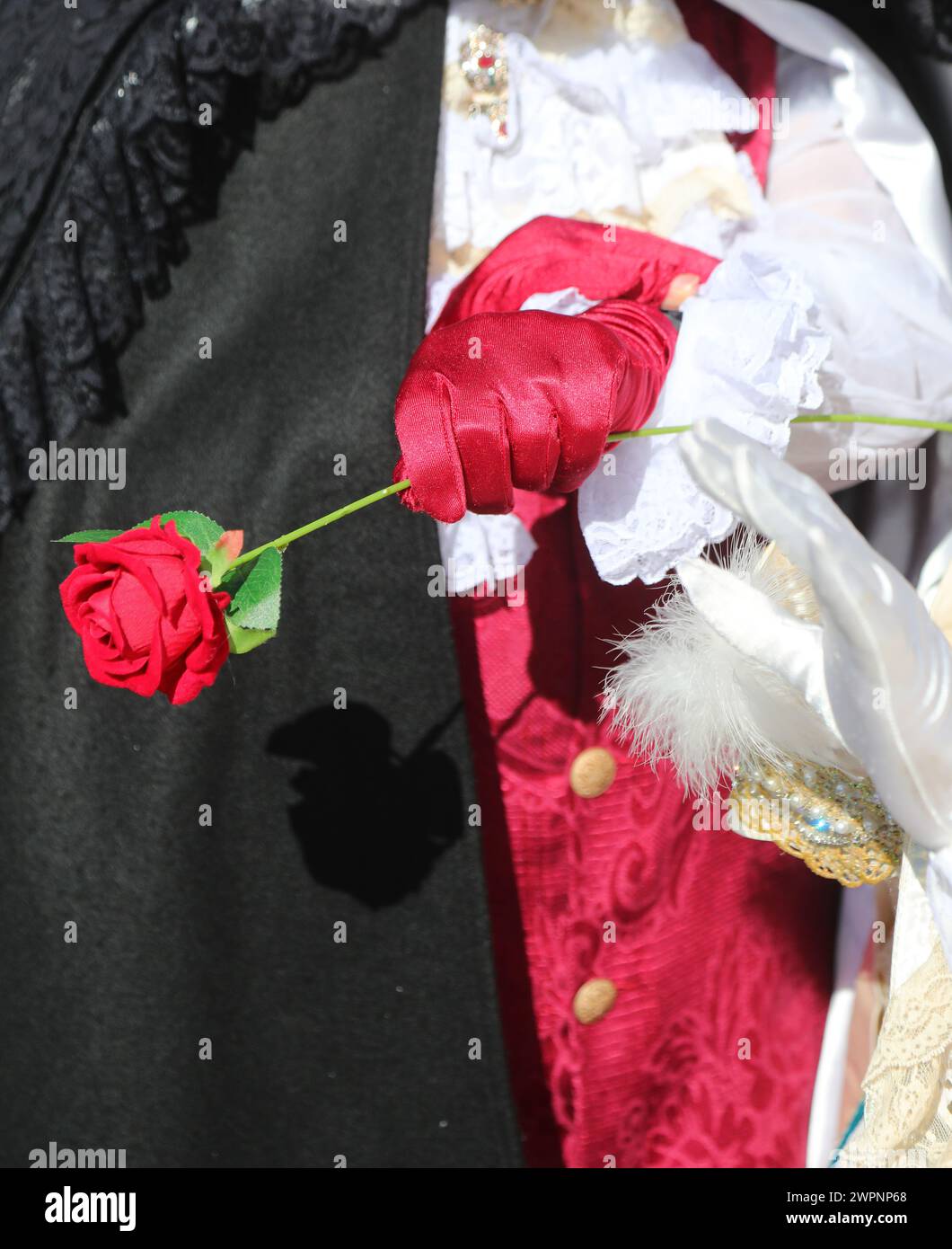 red gloved hand of a lover looking at the time because his beloved is ...