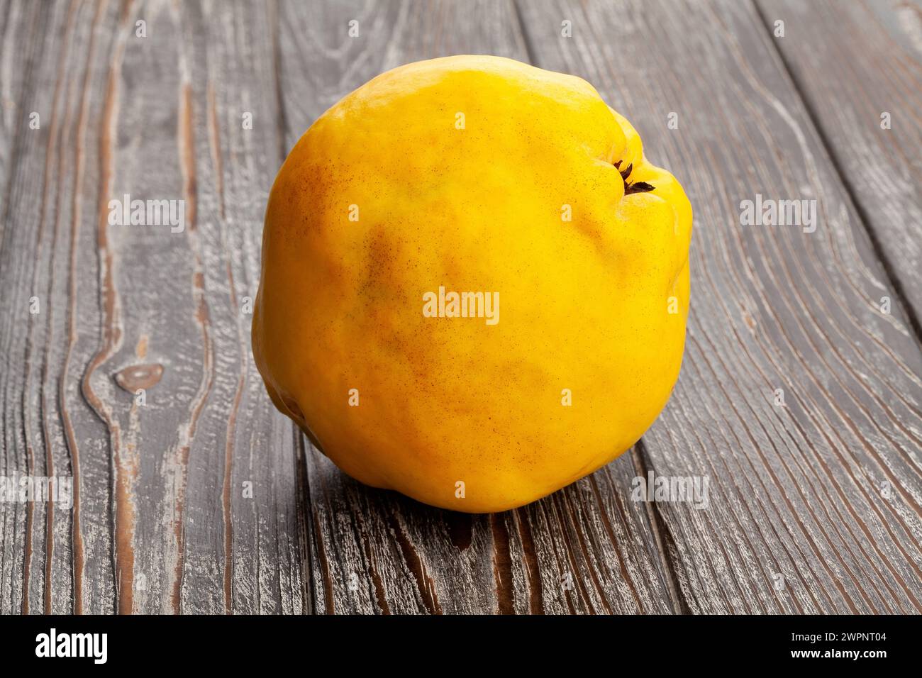 one quince on wood background Stock Photo - Alamy