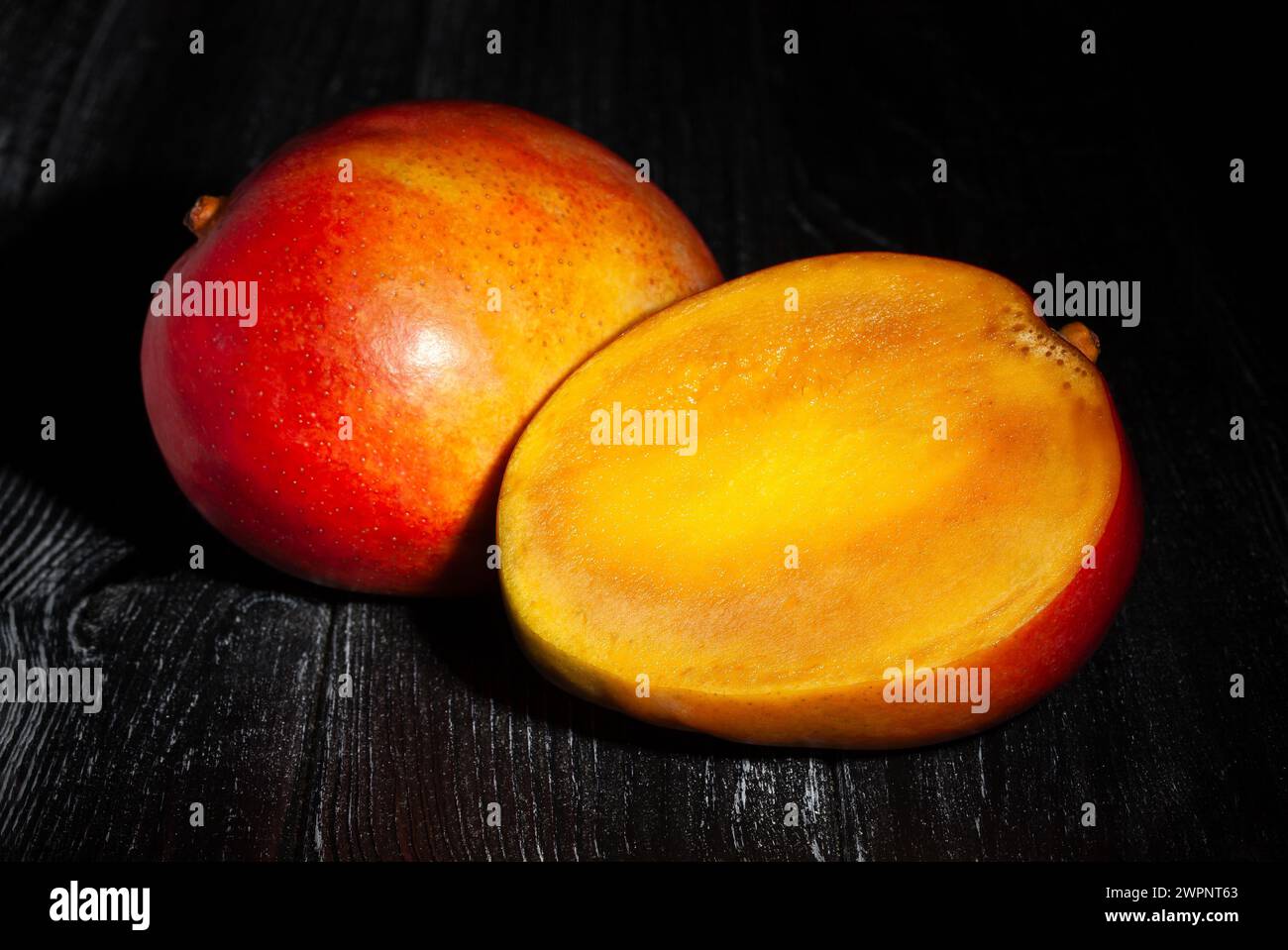 Fresh mango on black hi-res stock photography and images - Alamy