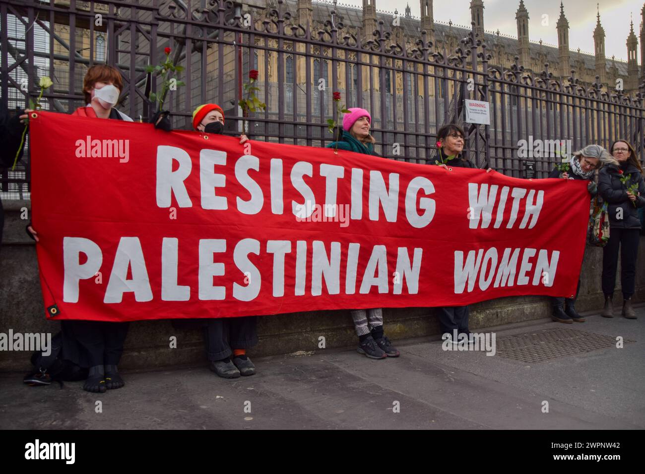 London, UK. 8th March 2024. Pro-Palestine protesters form a human chain ...