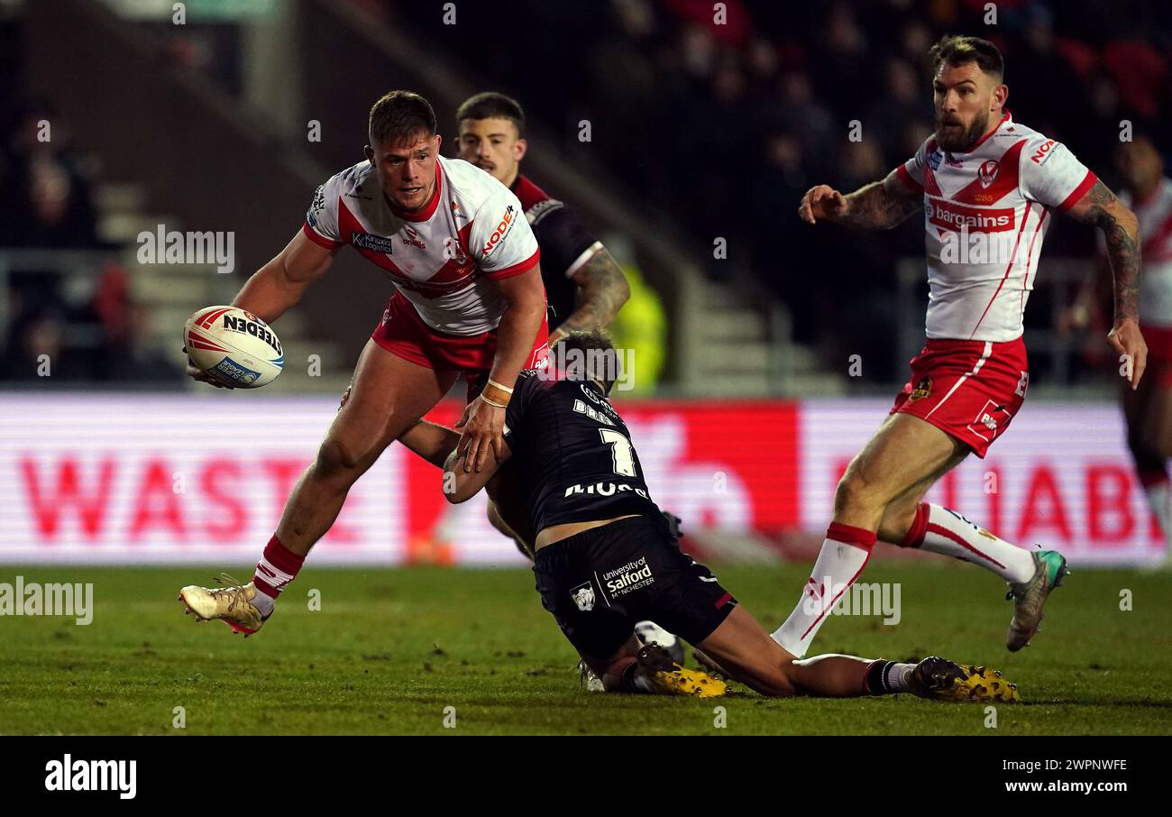 St Helens' Morgan Knowles is tackled by Salford Red Devils' Ryan ...