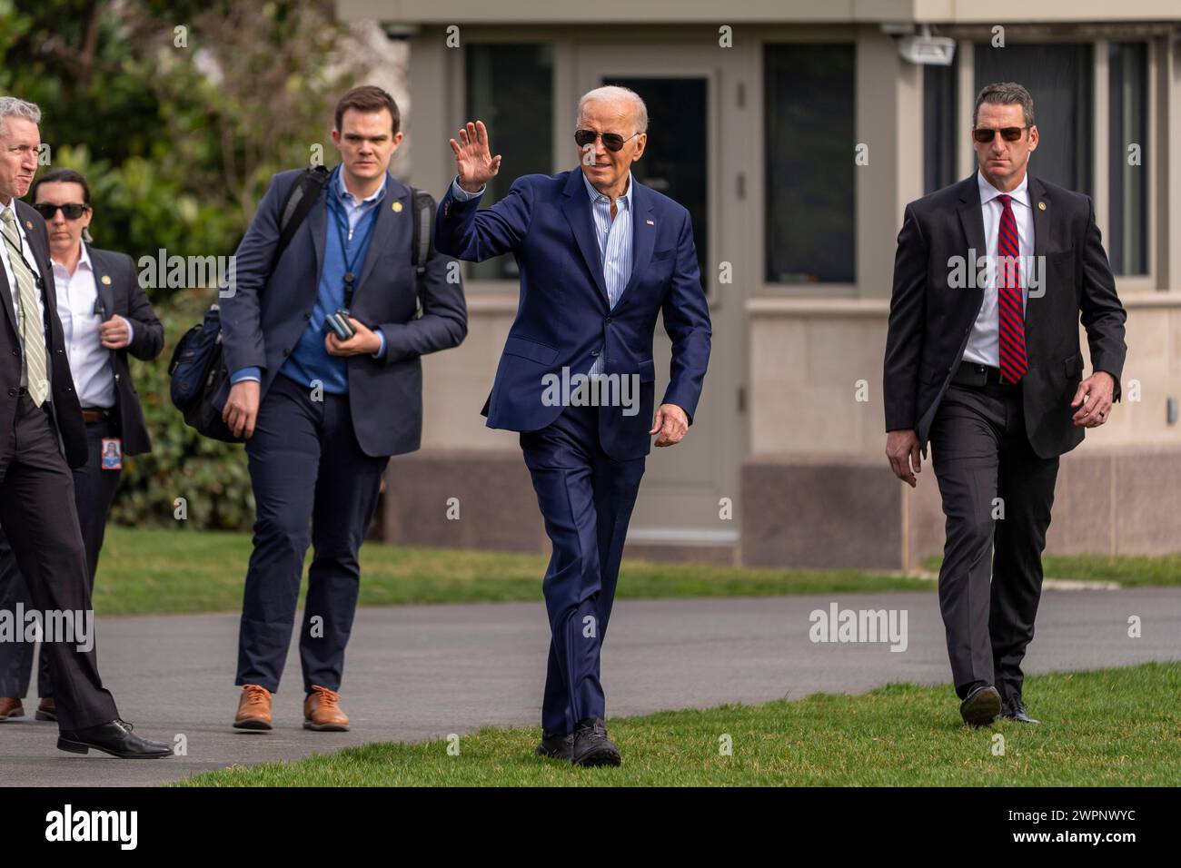 President Joe Biden waves as he walks toward Marine One on the South ...