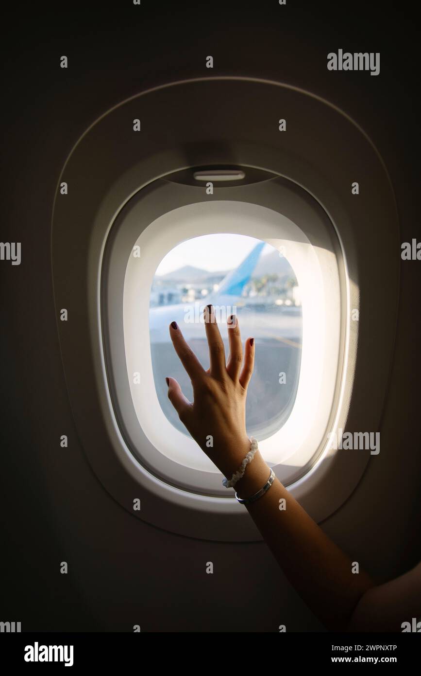 Female hand at the window of an airplane Stock Photo - Alamy