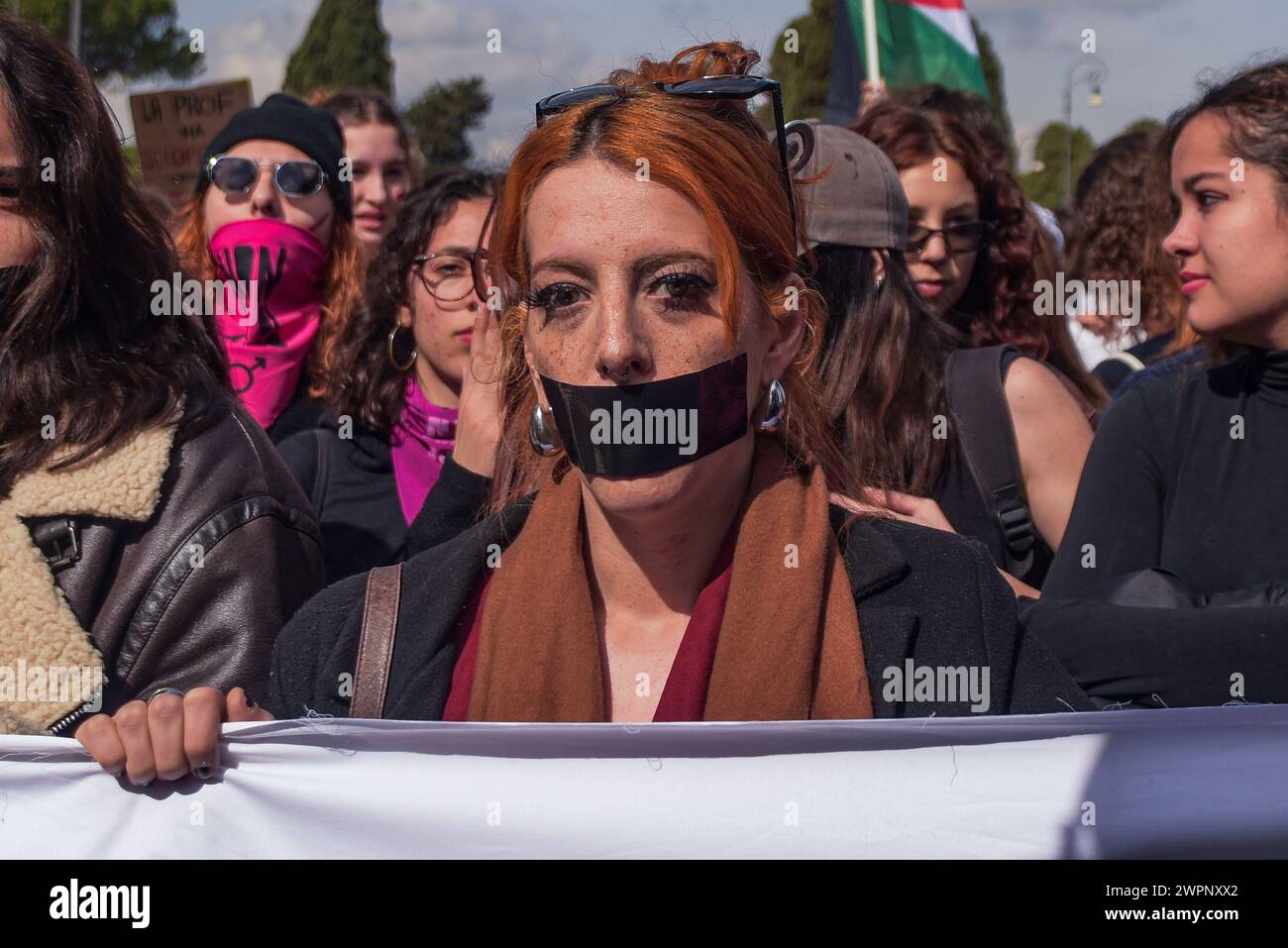 Rome, Italy. 08th Mar, 2024. A protester with her mouth covered in duct ...