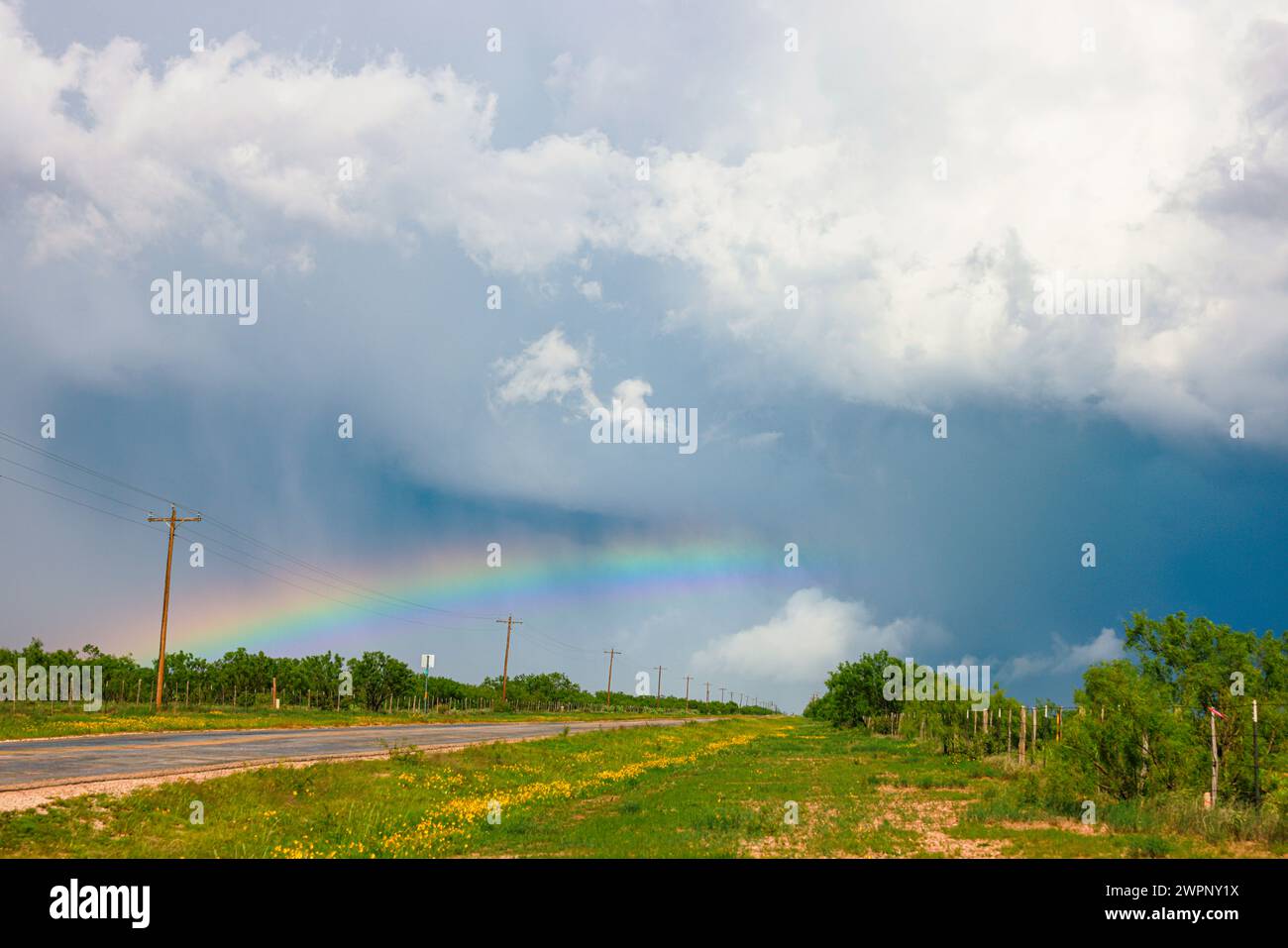 A colorful rainbow arches over the southwest Texas prairie Stock Photo ...