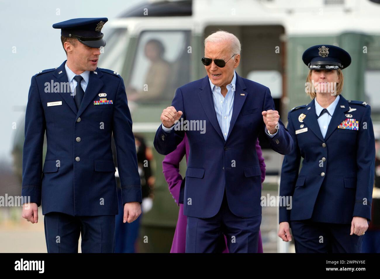 President Joe Biden walks with Capt. Eric Anderson, deputy director of ...