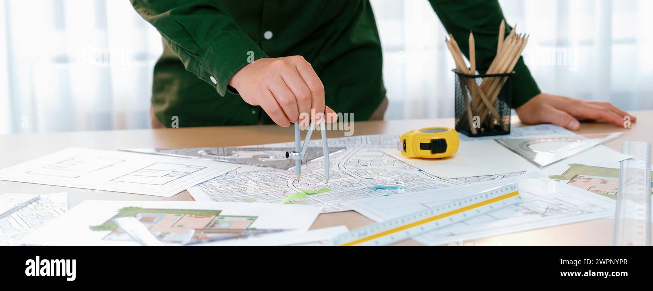 A portrait of architect using divider to measure blueprint. Architect ...