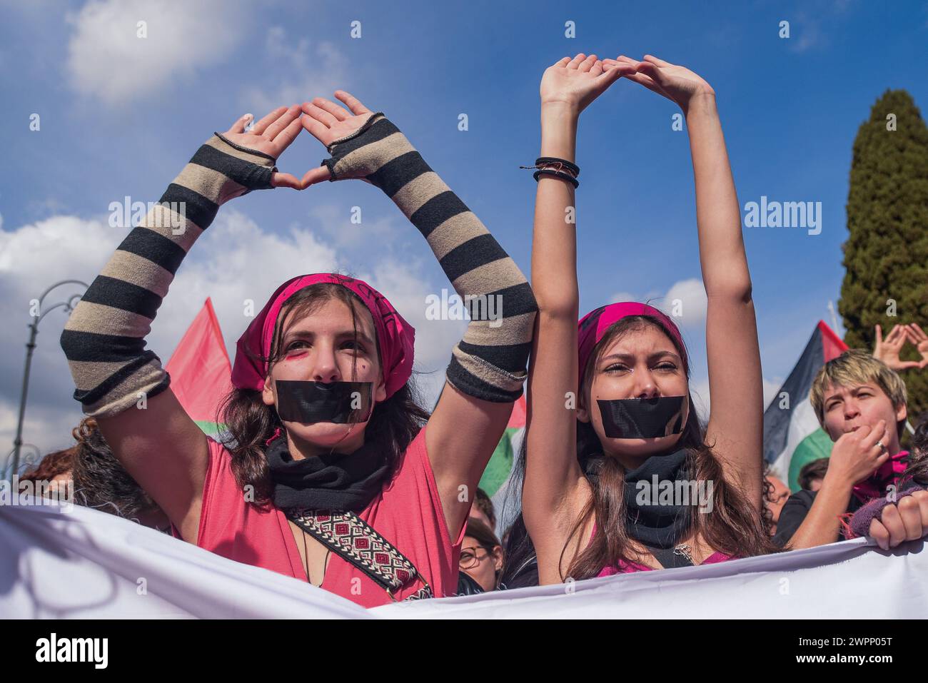 Rome, Italy. 08th Mar, 2024. Protesters, with their mouth covered in ...