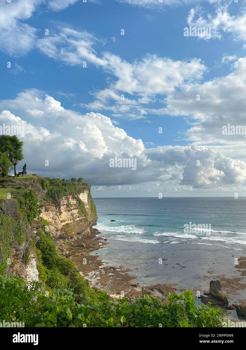 The sheer cliffs of the southern coast of Bali are washed by a clear ...