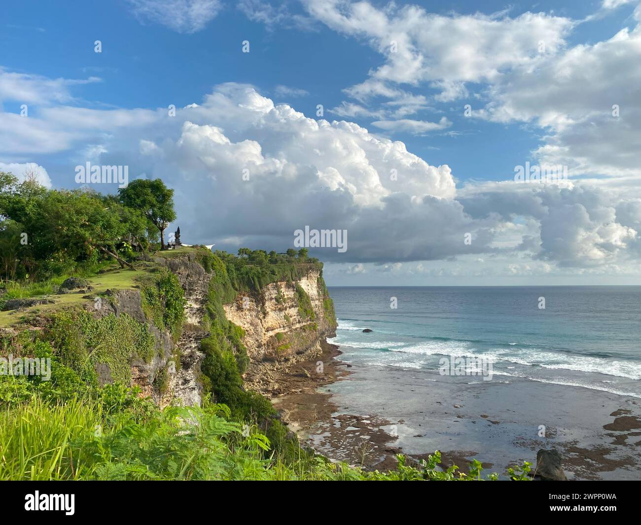 The sheer cliffs of the southern coast of Bali are washed by a clear ...