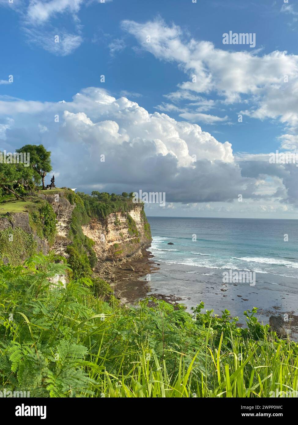 The sheer cliffs of the southern coast of Bali are washed by a clear ...