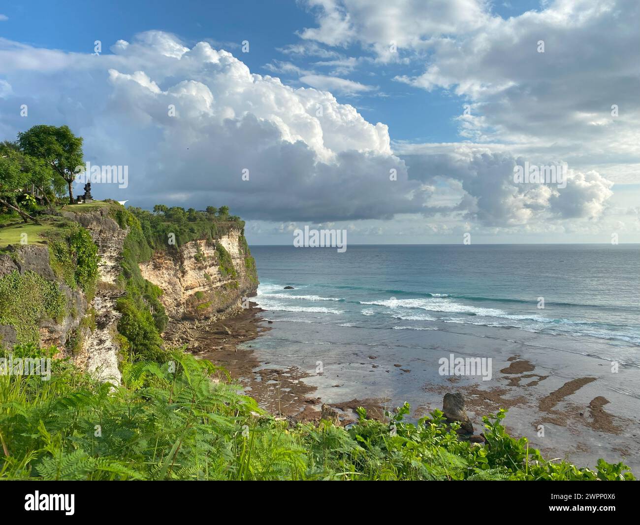 The sheer cliffs of the southern coast of Bali are washed by a clear ...