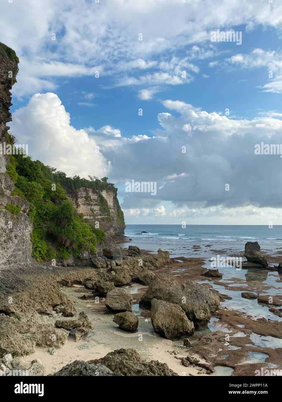 The sheer cliffs of the southern coast of Bali are washed by a clear ...