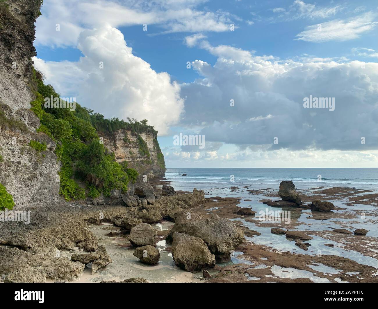 The sheer cliffs of the southern coast of Bali are washed by a clear ...