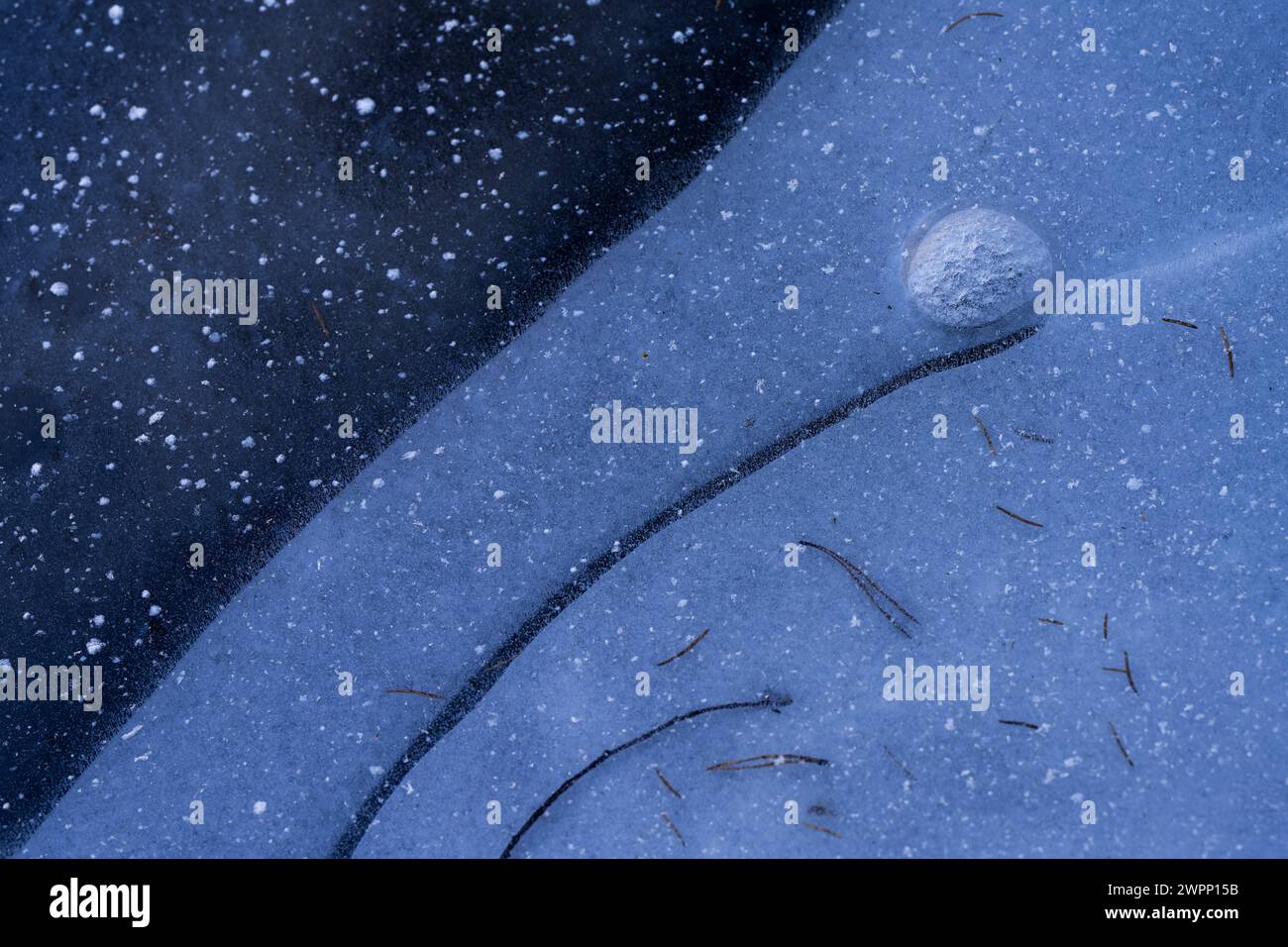 Patterns and structures in the ice on a frozen lake, close-up, Germany ...