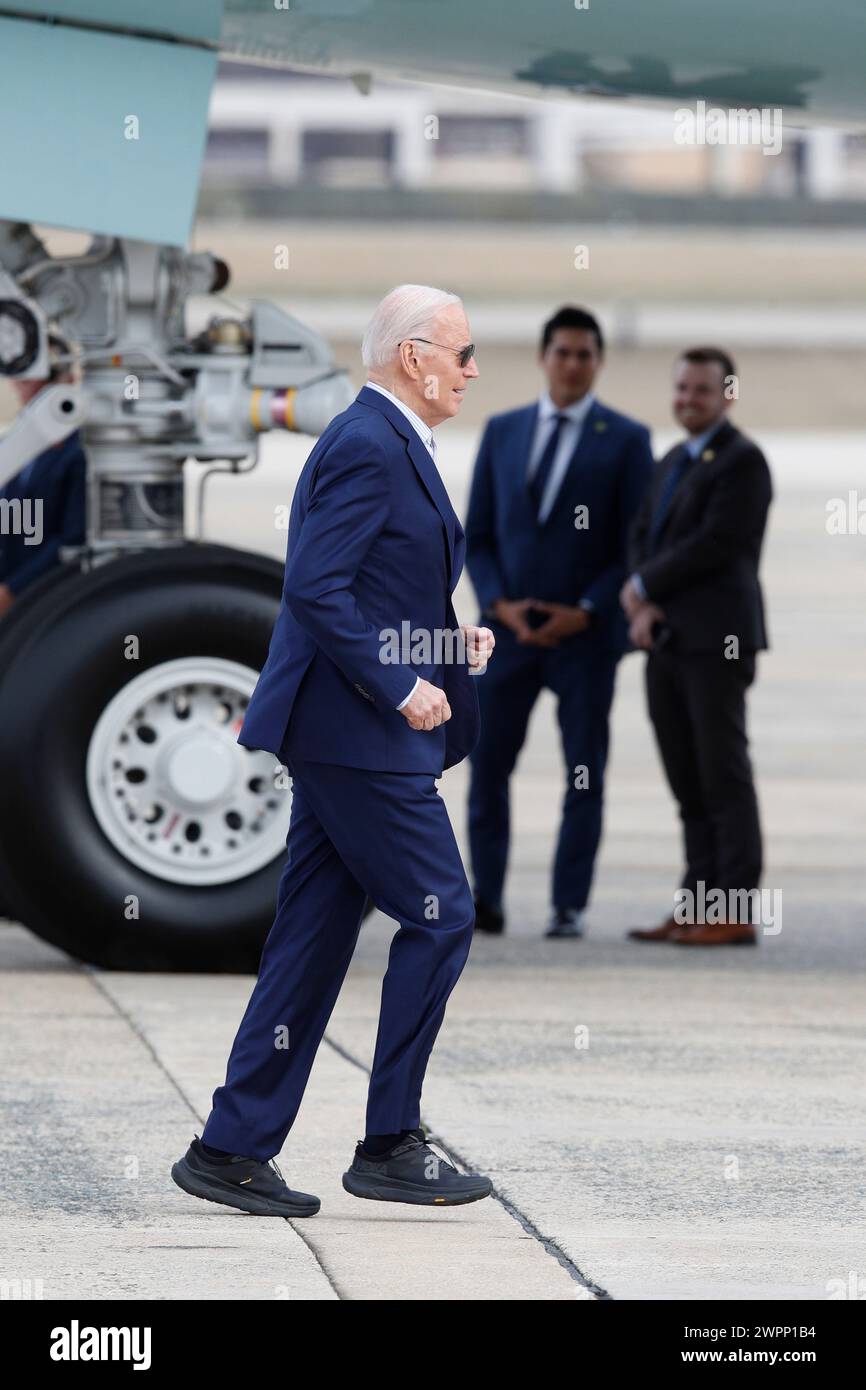 President Joe Biden jogs toward members of the media before boarding ...